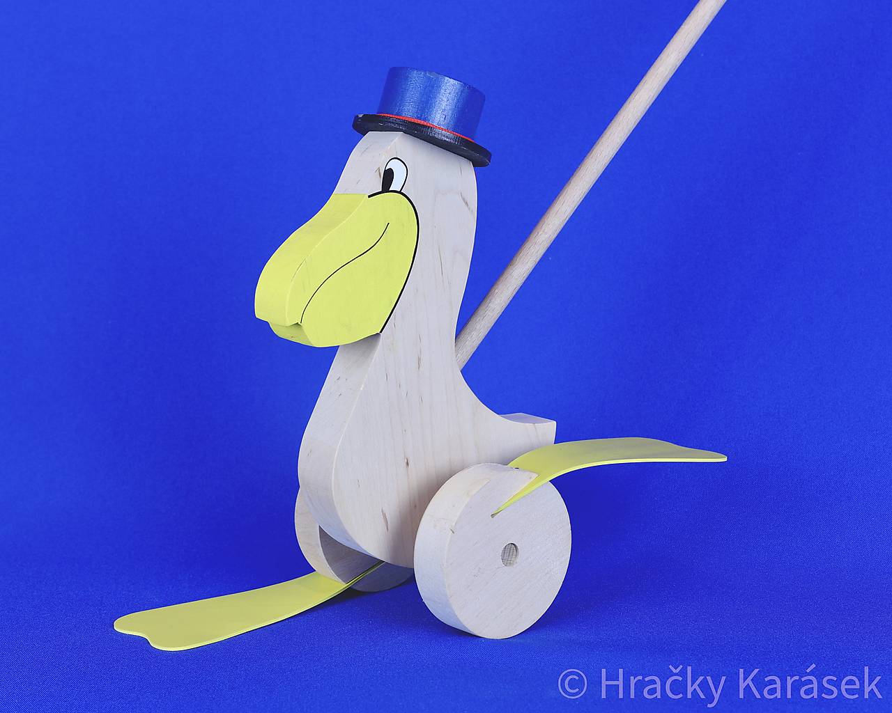 Plácačka - Pelikán na tyčke s klobúkom / drevene.hracky - SAShE.sk